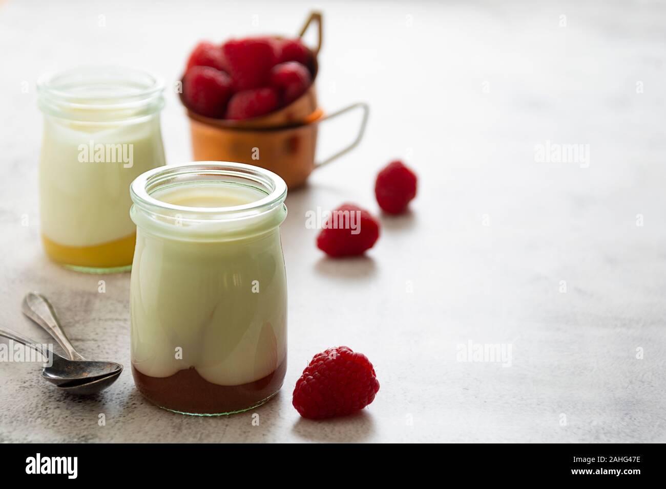Fresh yogurt in glass jar with berry fruits. Healthy food, milk diary ...