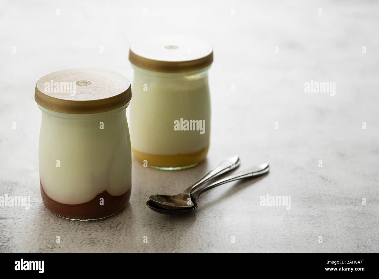 Fresh yogurt in glass jar with fruit jam. Healthy food, milk diary ...