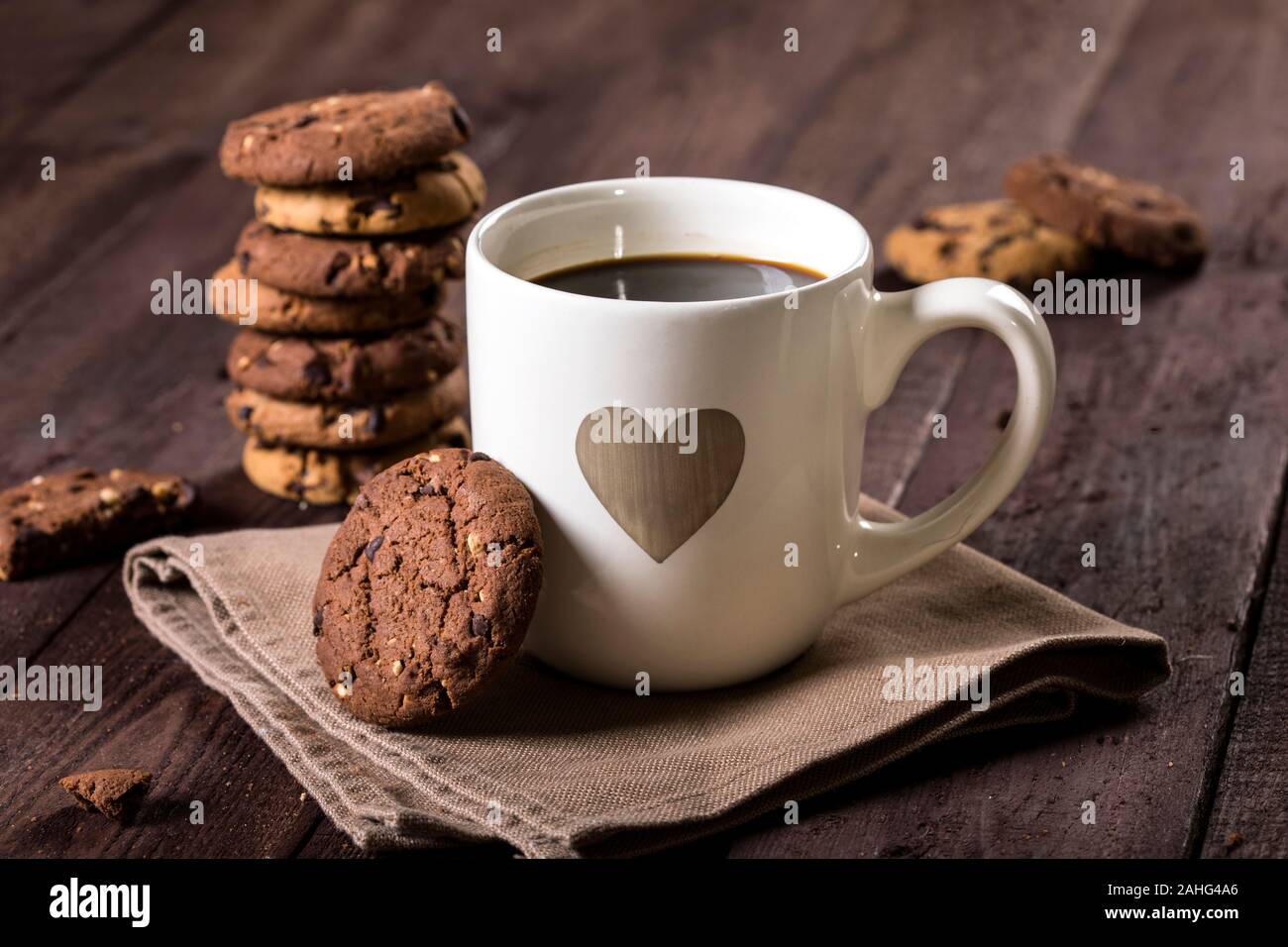 Cup of coffee with heart and chocolate chip cookies on rustic wooden ...