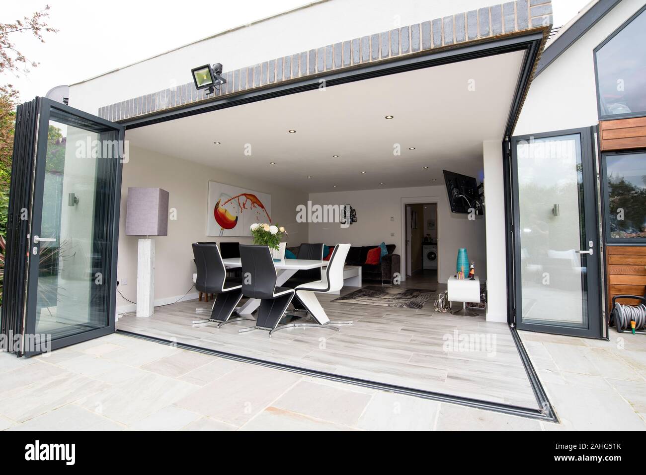 Modern home with wide open bi fold patio doors Stock Photo - Alamy