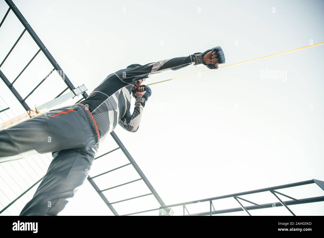 Bottom view of the boxer training with the rubber rope Stock Photo - Alamy