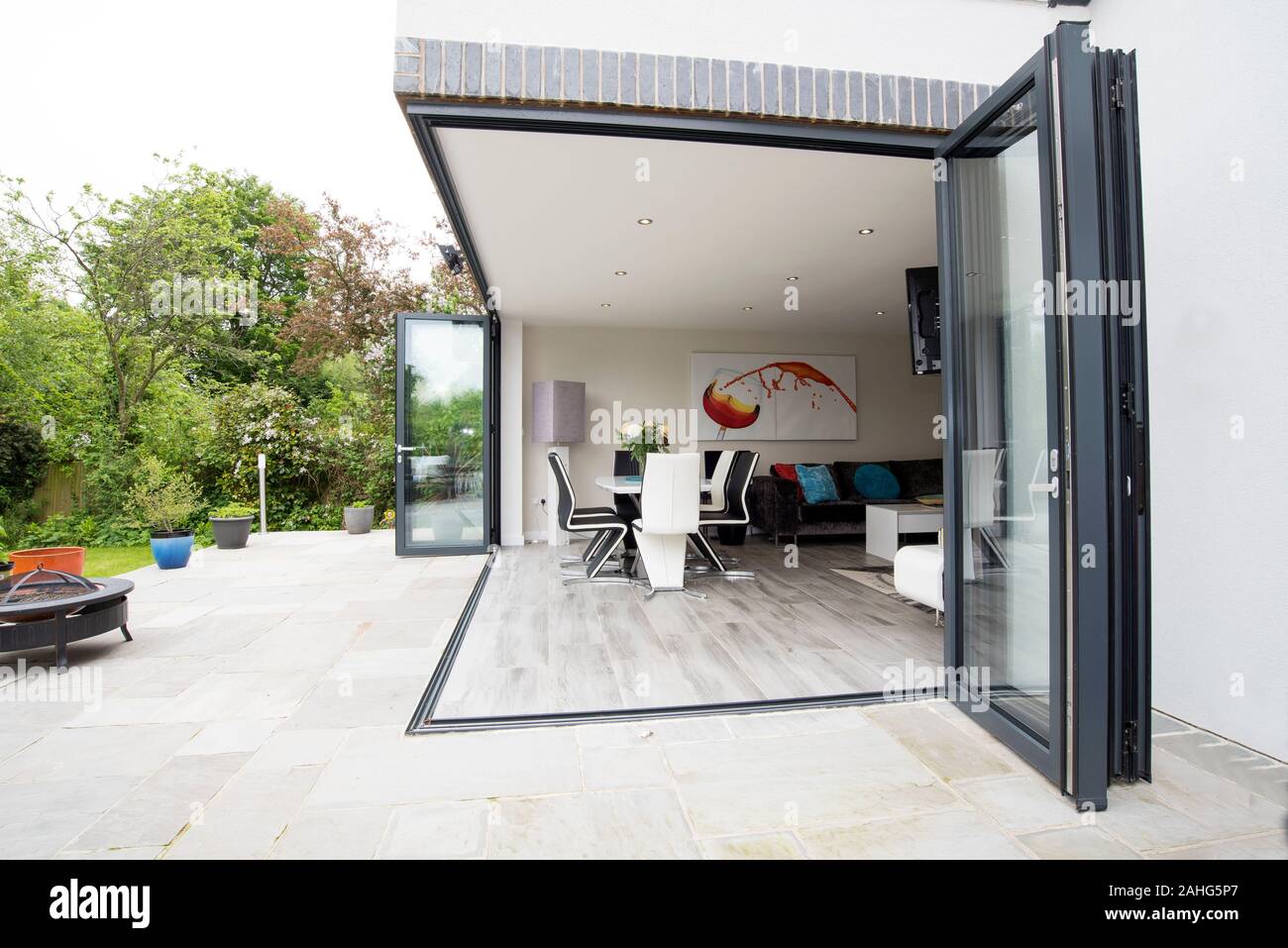 Modern home with open bi fold patio doors Stock Photo - Alamy