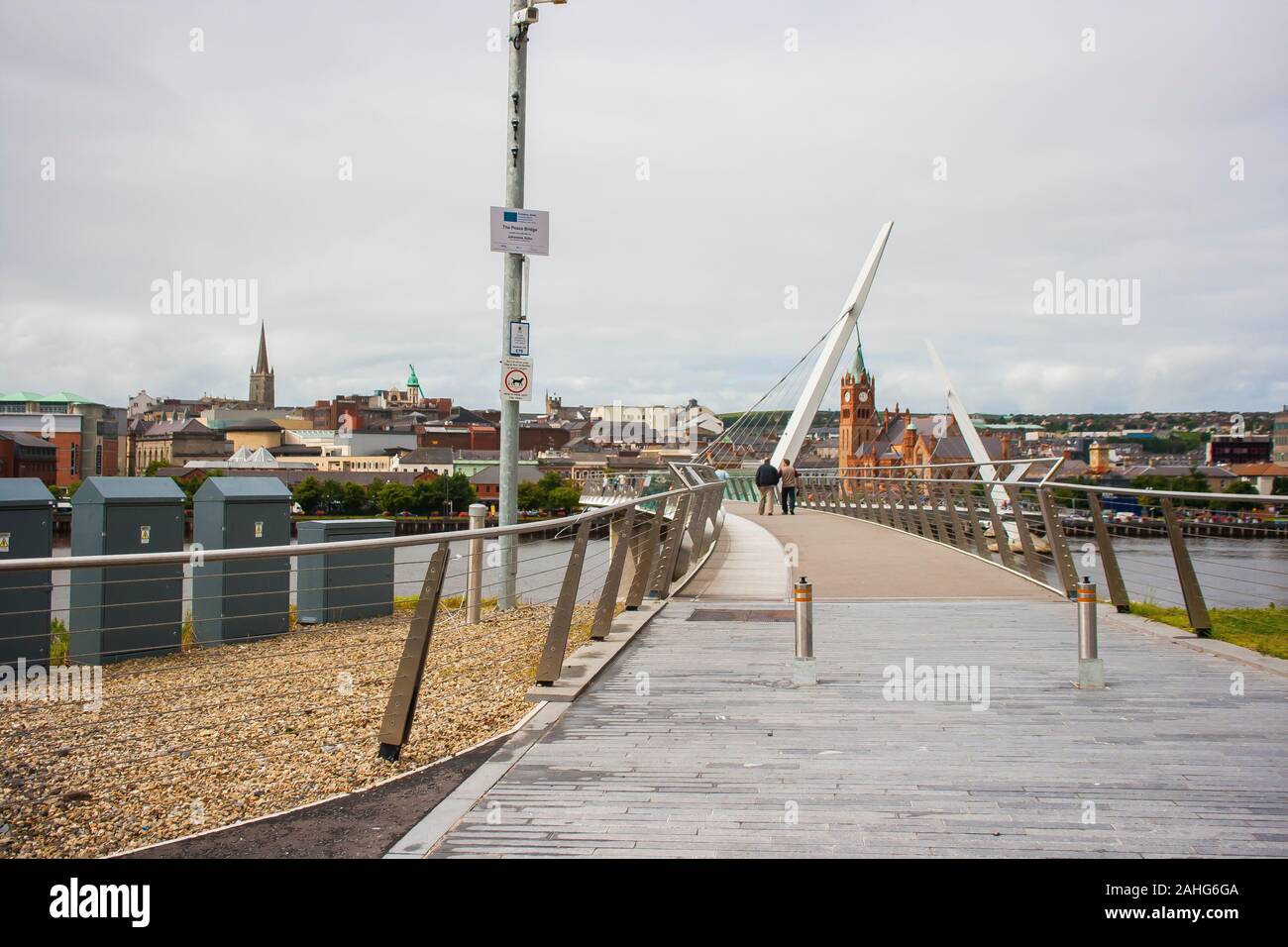 13 July 2014 Pedestrians crossing the modern Derry Peace Bridge from ...