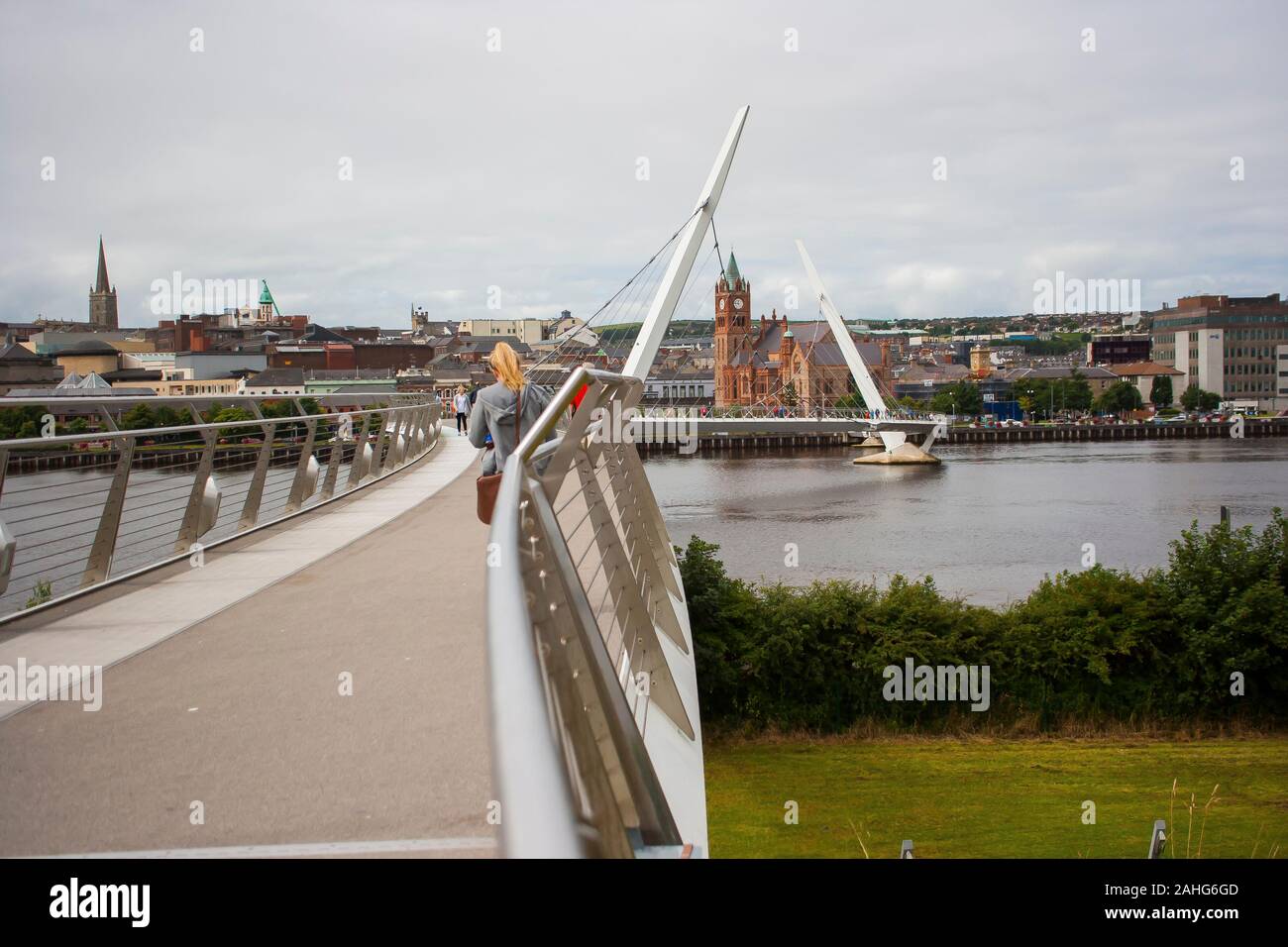13 July 2014 Pedestrians crossing the modern Derry Peace Bridge from ...