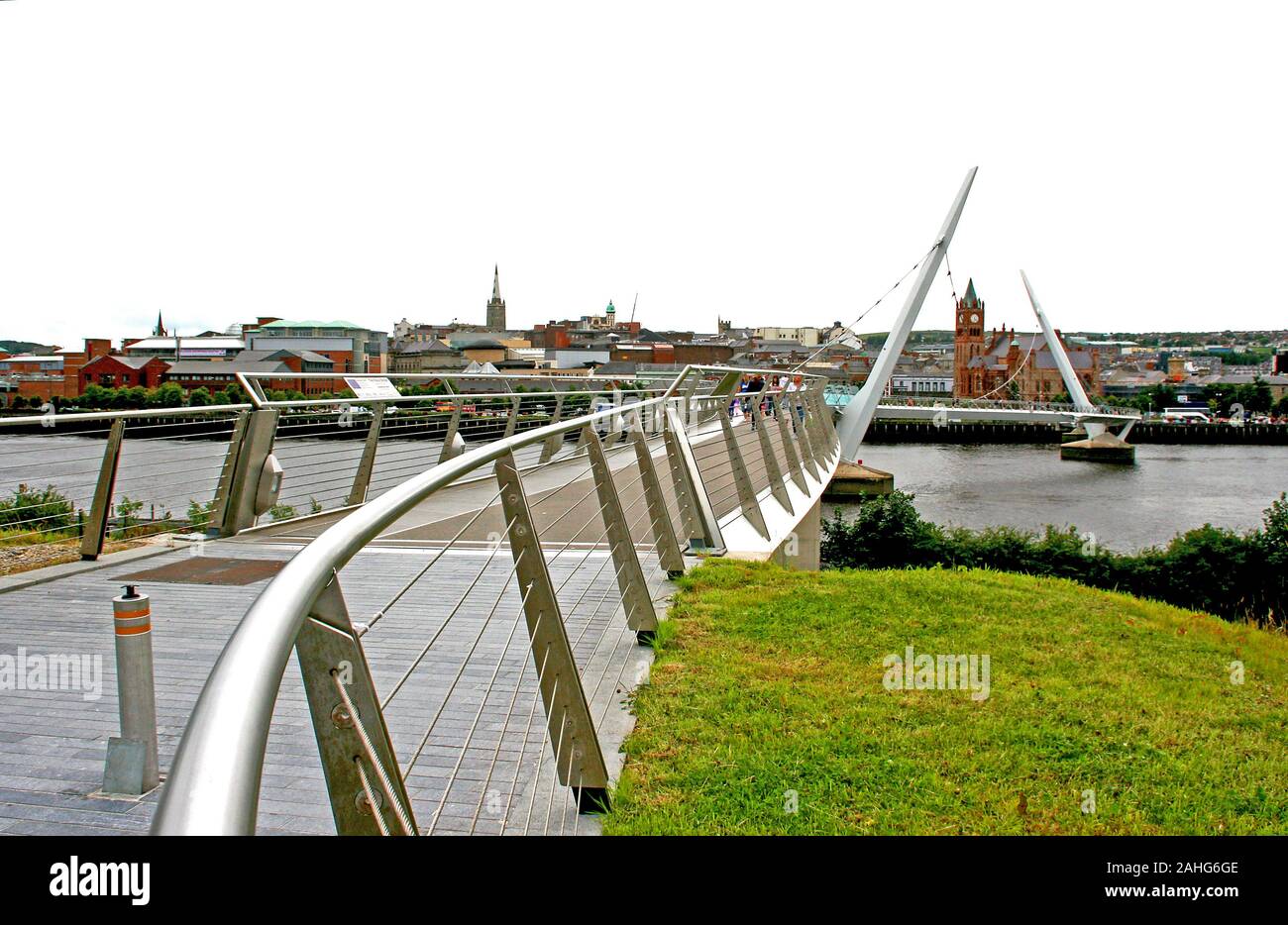 13 July 2014 Pedestrians crossing the modern Derry Peace Bridge from ...