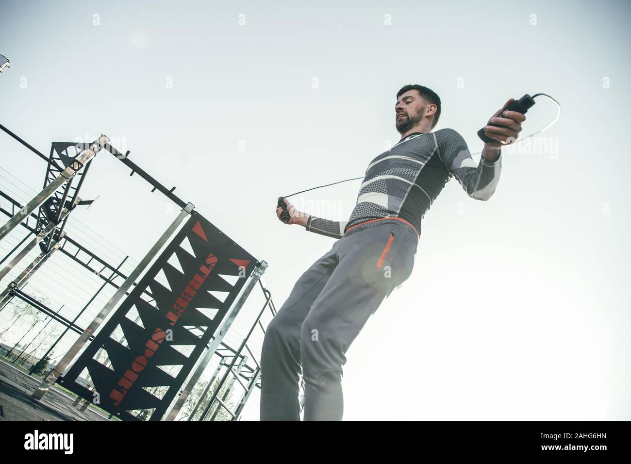 Bearded boxer using jumping rope while training outdoors Stock Photo ...