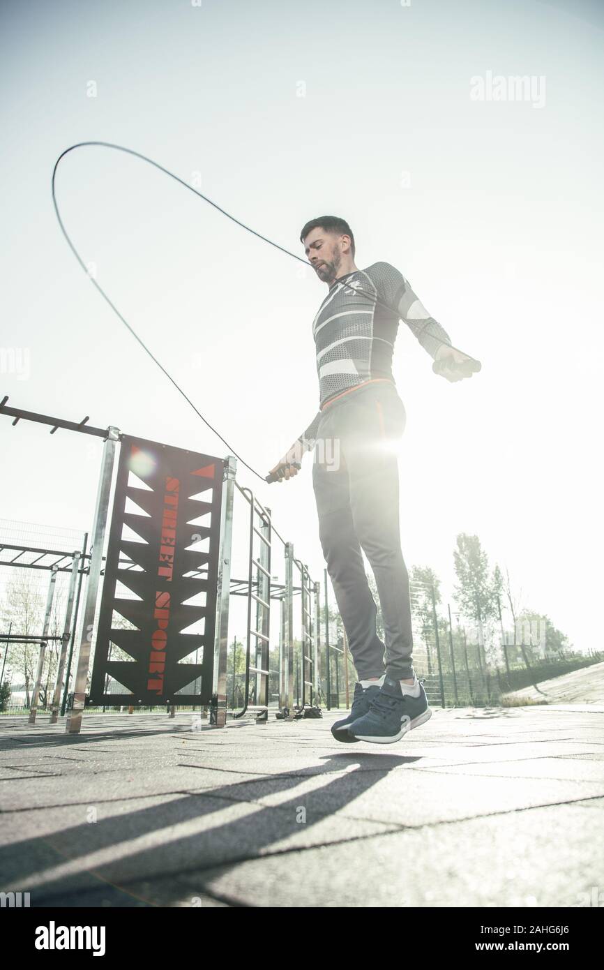 Professional sportsman using jumping rope while training Stock Photo ...