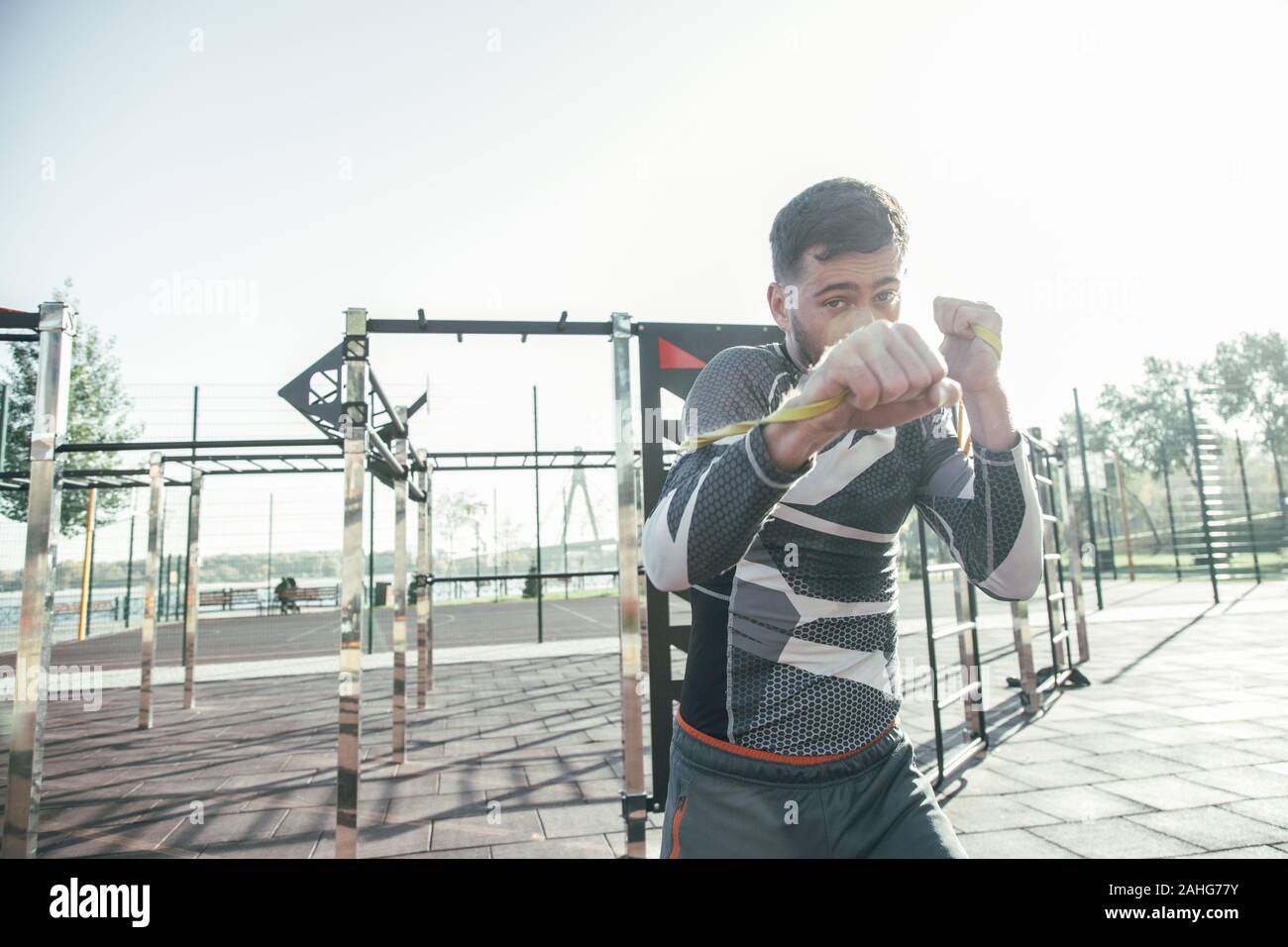 Professional boxer wearing rubber rope on his fists while training ...