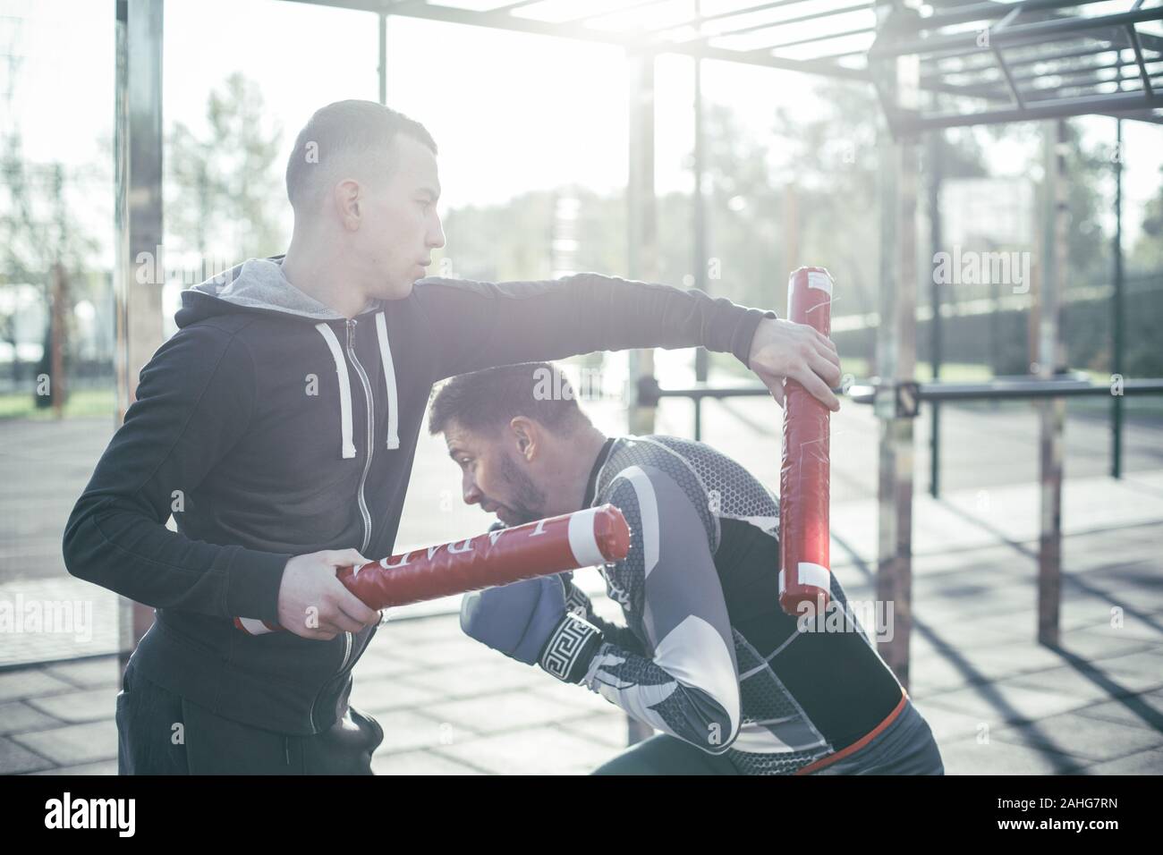 Waist up of the movement during the boxing training with boxing sticks ...