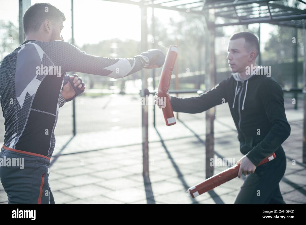 Strong boxer performing his punch while using boxing sticks Stock Photo ...