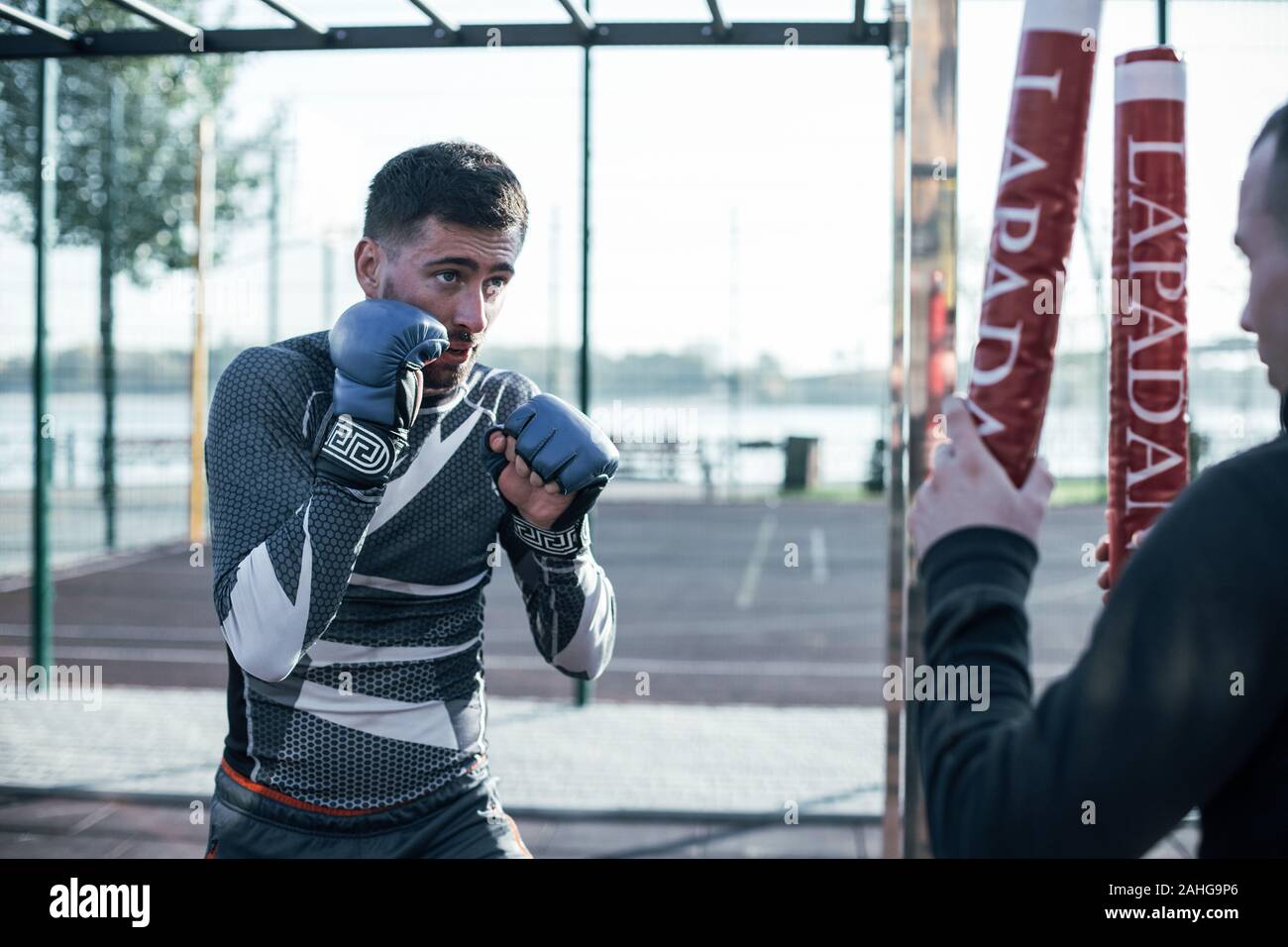 Confident man looking at the boxing stick and performing the stance ...