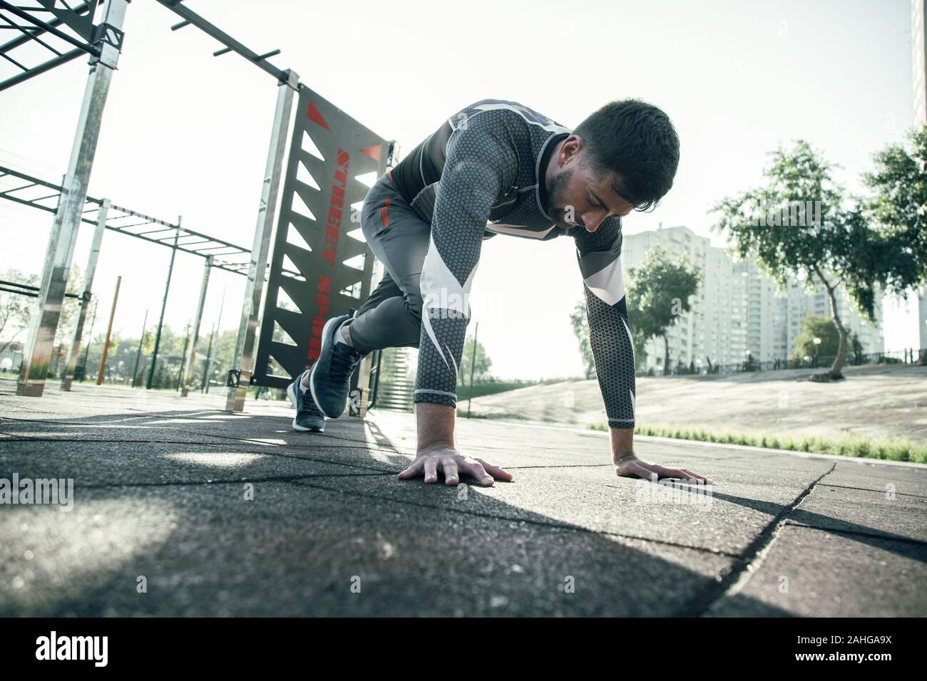 Calm sportsman leaning tot eh ground while doing push ups Stock Photo ...