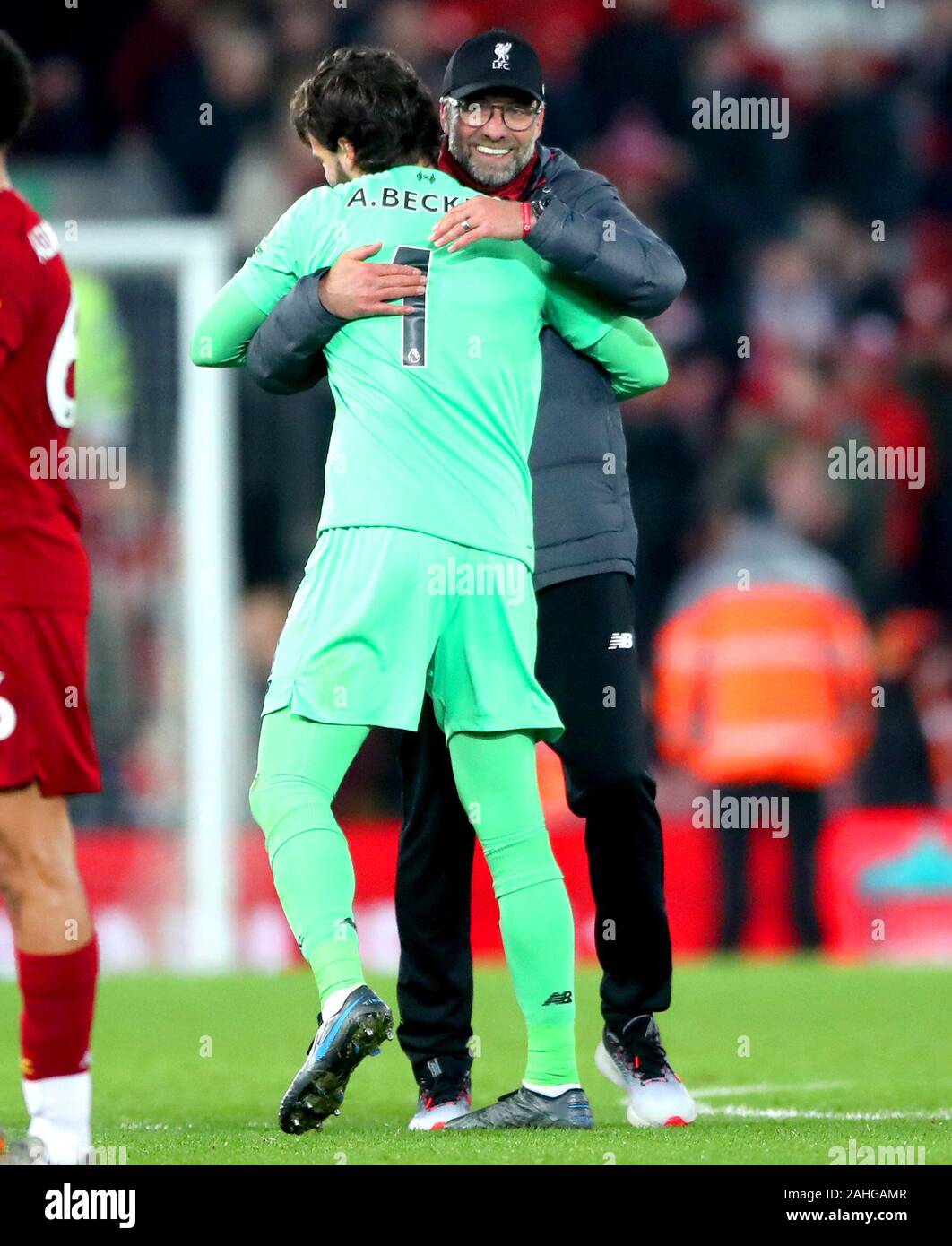 Liverpool manager Jurgen Klopp (right) hugs Alisson at the end of the ...