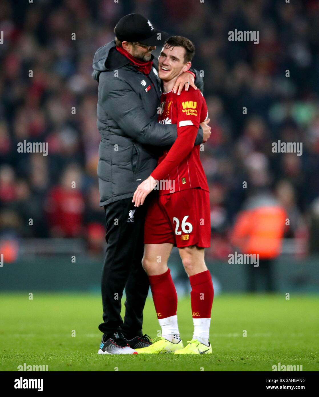 Liverpool manager Jurgen Klopp (left) hugs Andrew Robertson at the end ...