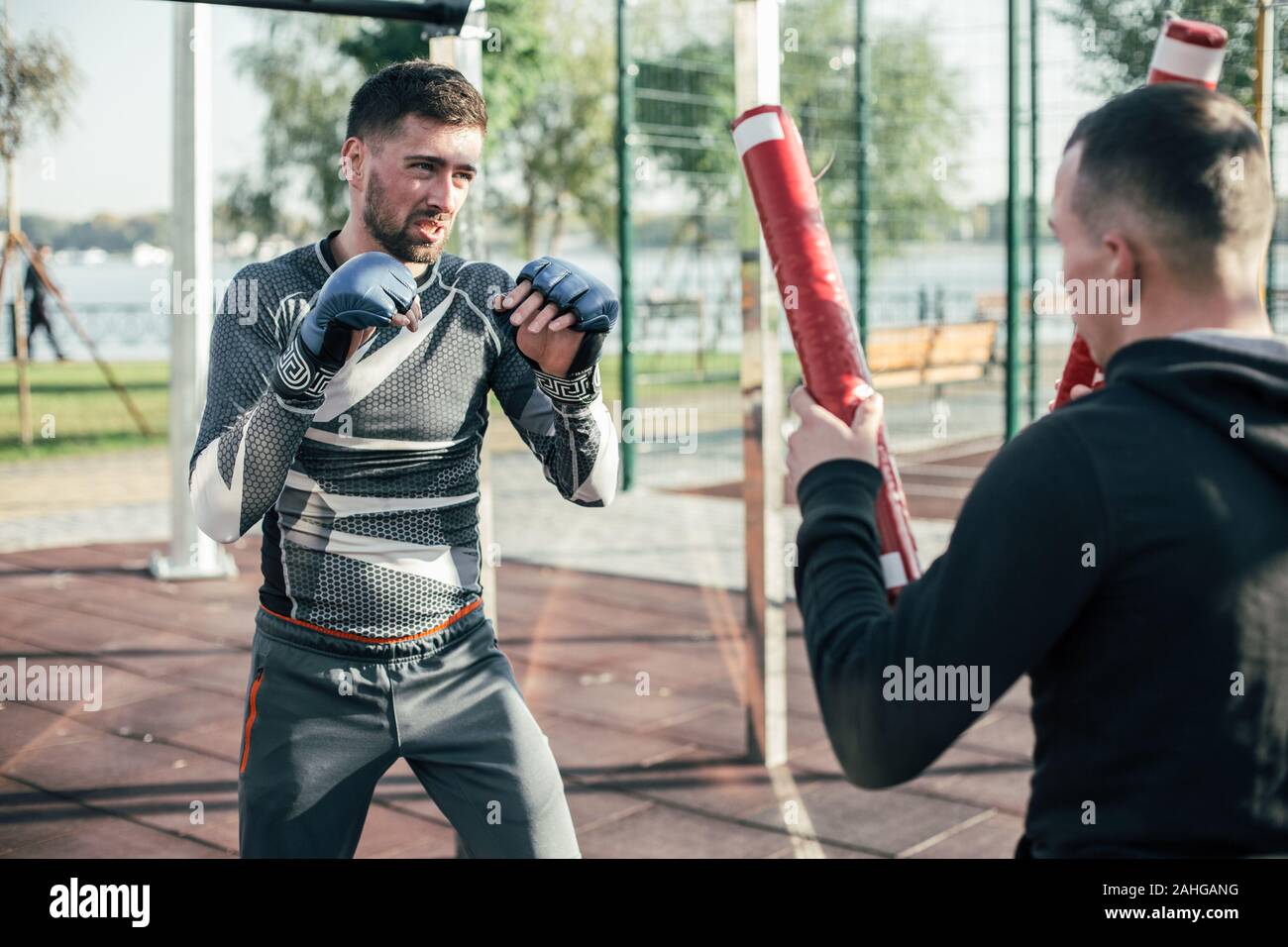 Serious boxer standing outdoors and looking at the boxing sticks Stock ...