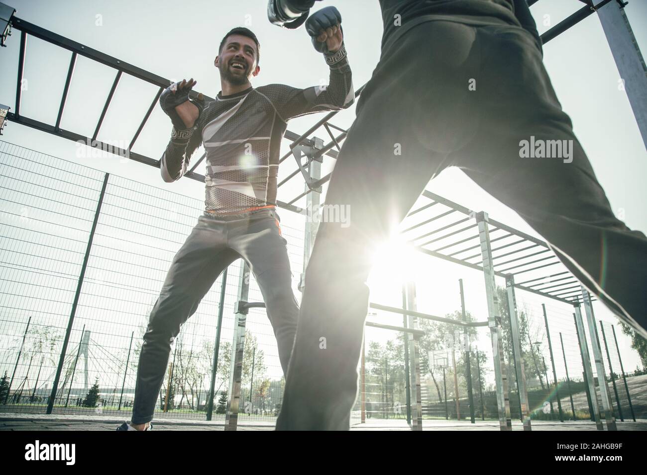 Happy boxer smiling while training with his friend Stock Photo - Alamy