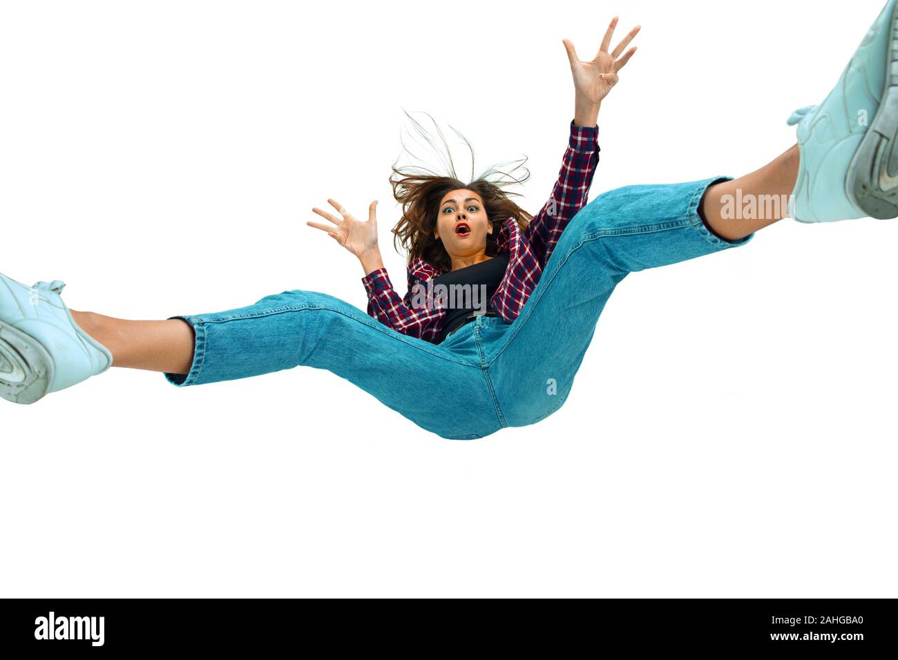 A second before falling. Caucasian young girl falling down in moment ...