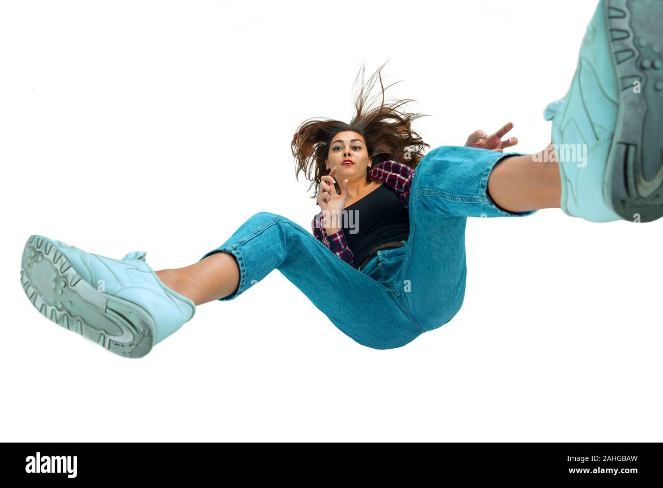 A second before falling. Caucasian young girl falling down in moment ...