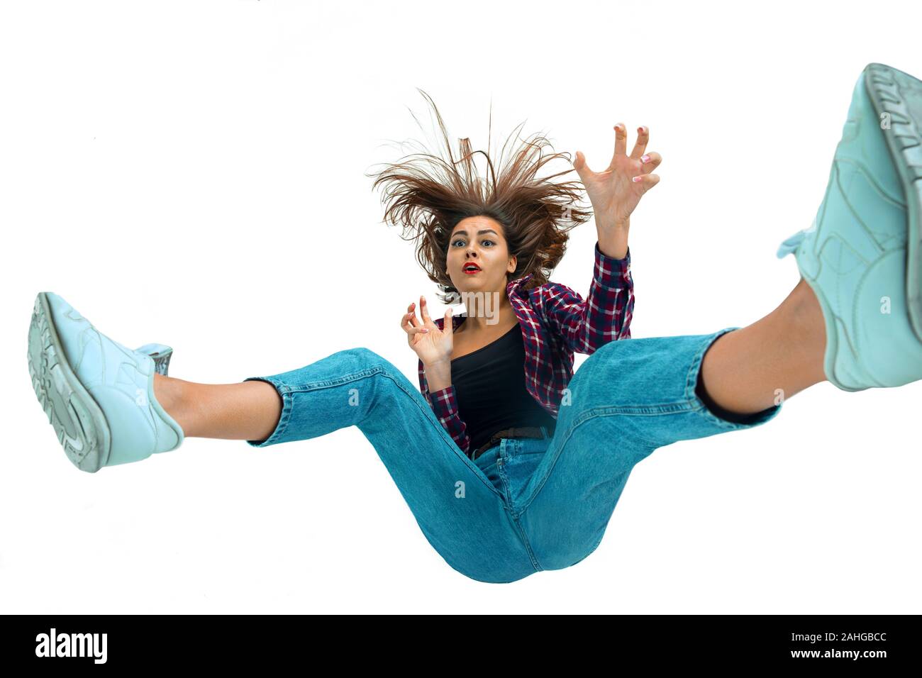 A second before falling. Caucasian young girl falling down in moment ...