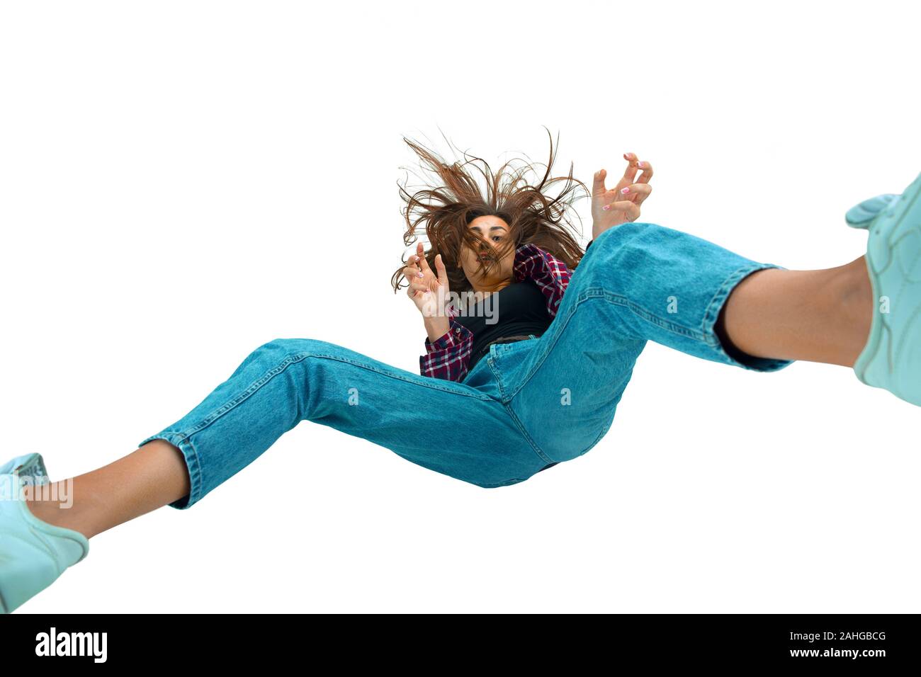 A second before falling. Caucasian young girl falling down in moment ...