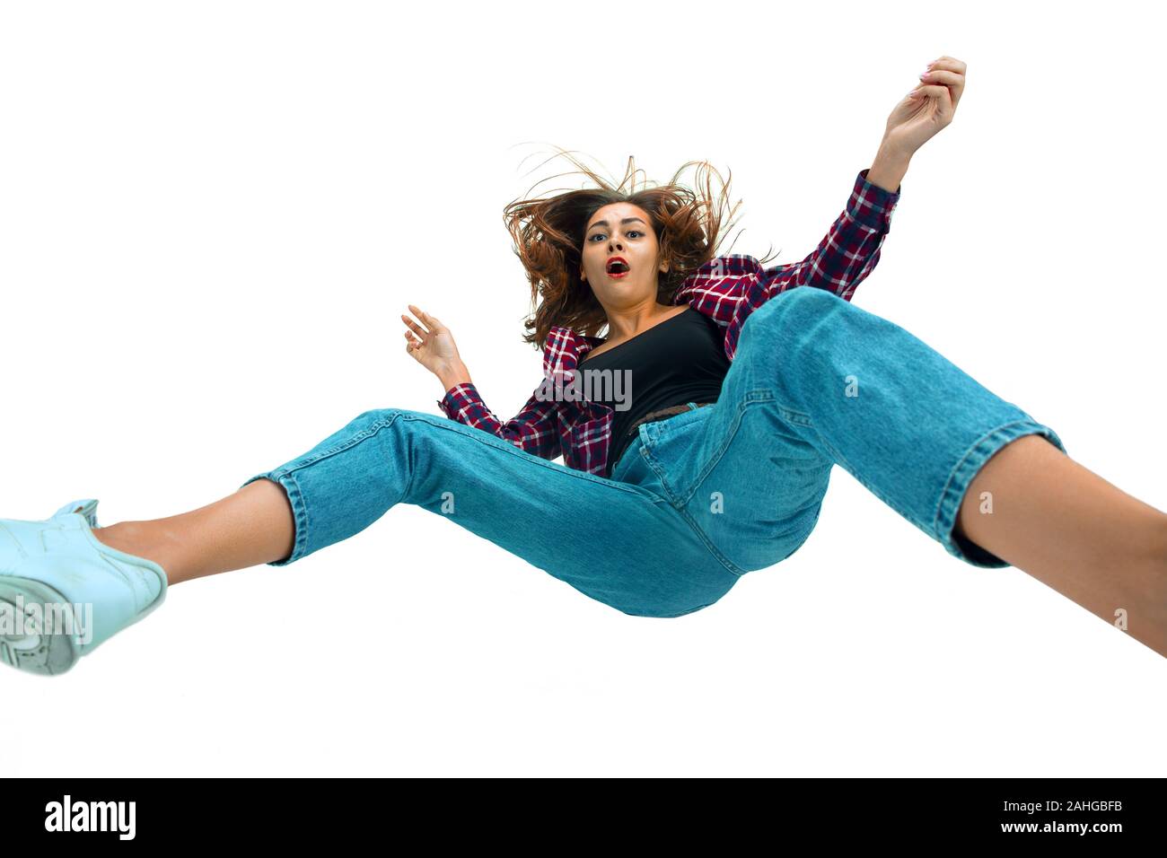 A second before falling. Caucasian young girl falling down in moment ...