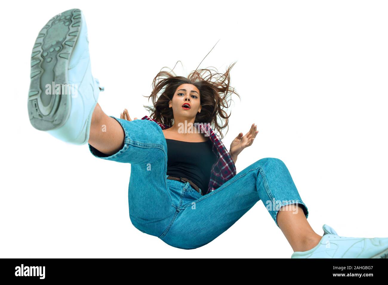 A second before falling. Caucasian young girl falling down in moment ...