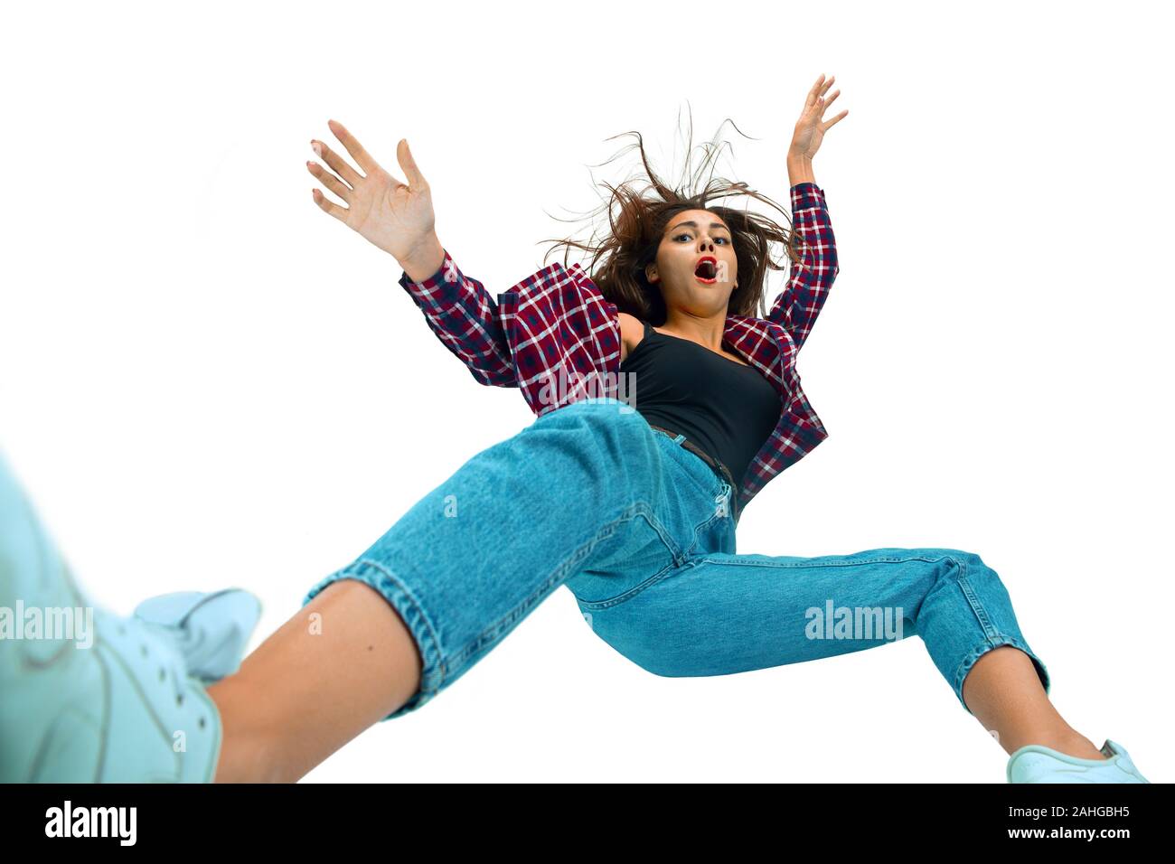 A second before falling. Caucasian young girl falling down in moment ...