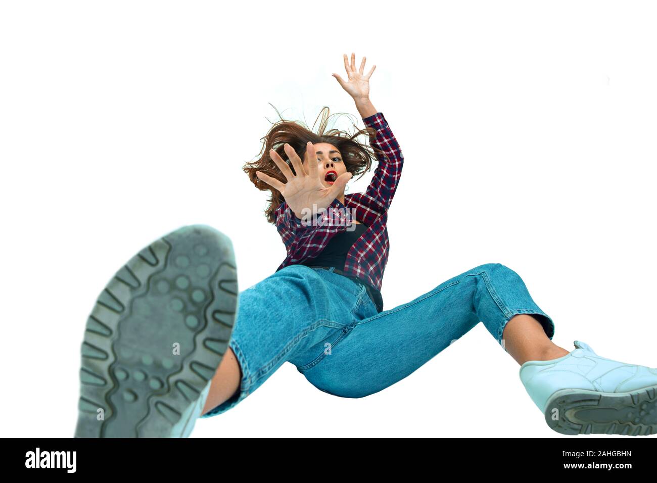 A second before falling. Caucasian young girl falling down in moment ...