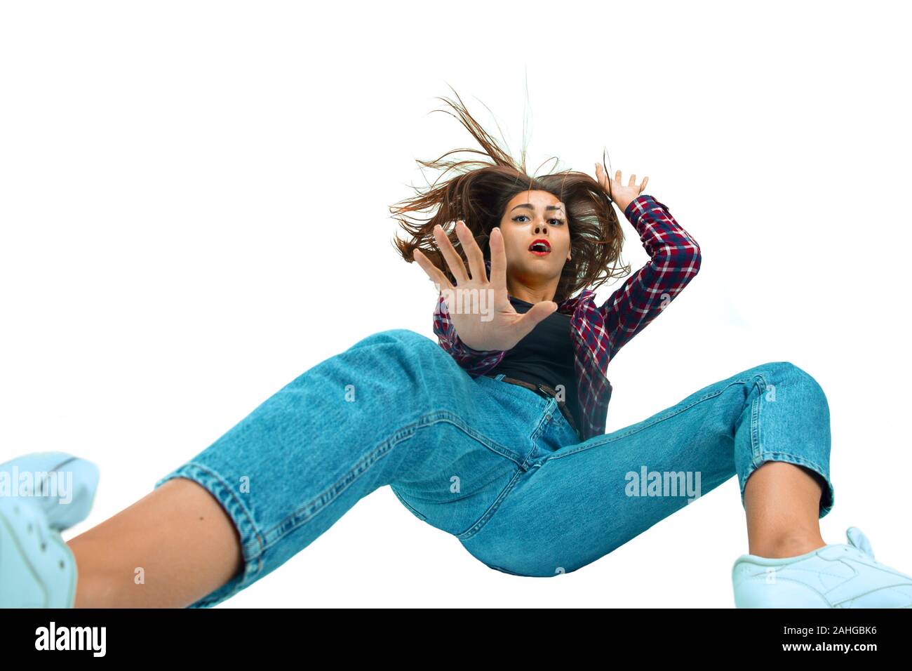 A second before falling. Caucasian young girl falling down in moment ...