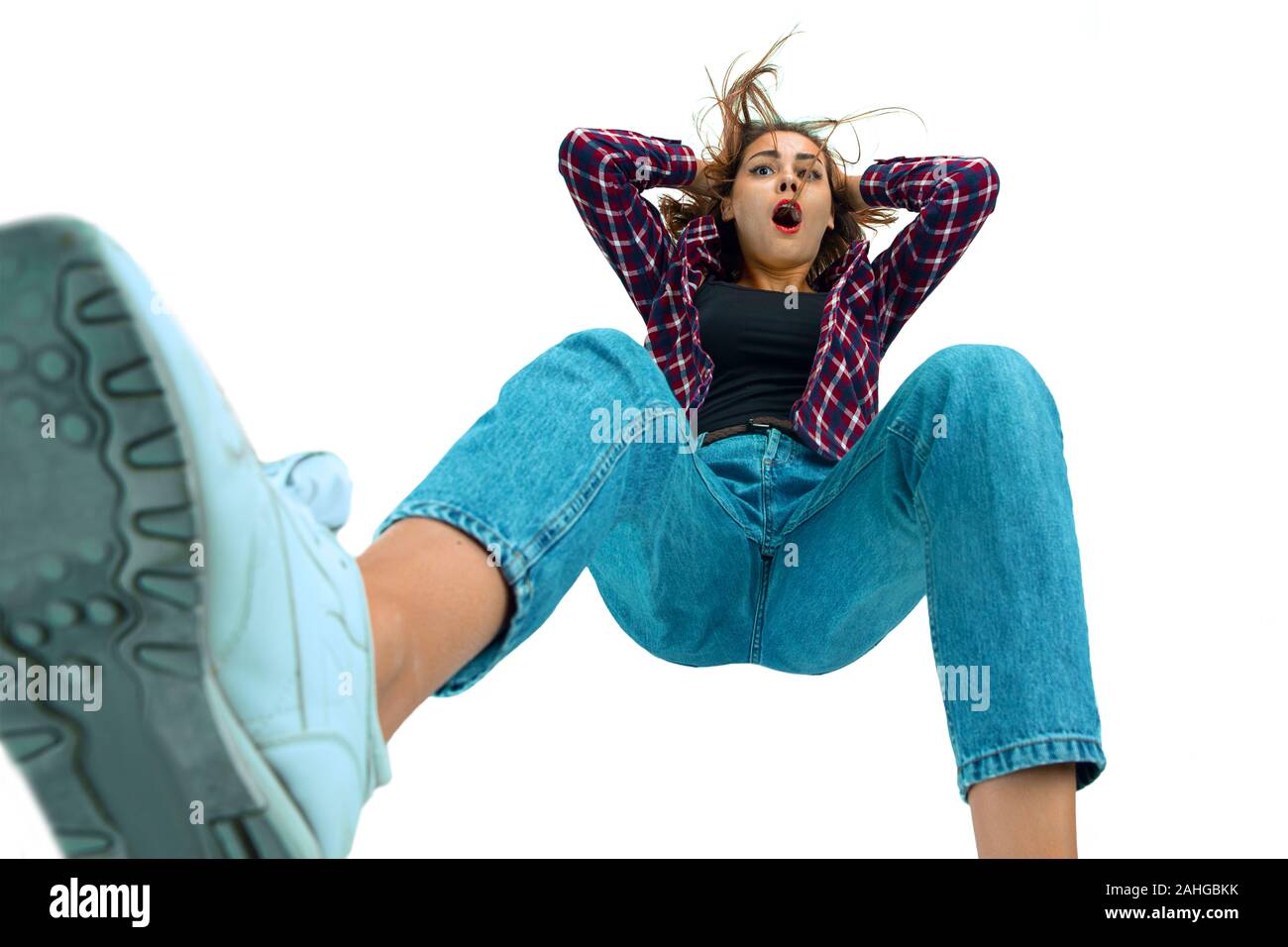 A second before falling. Caucasian young girl falling down in moment ...