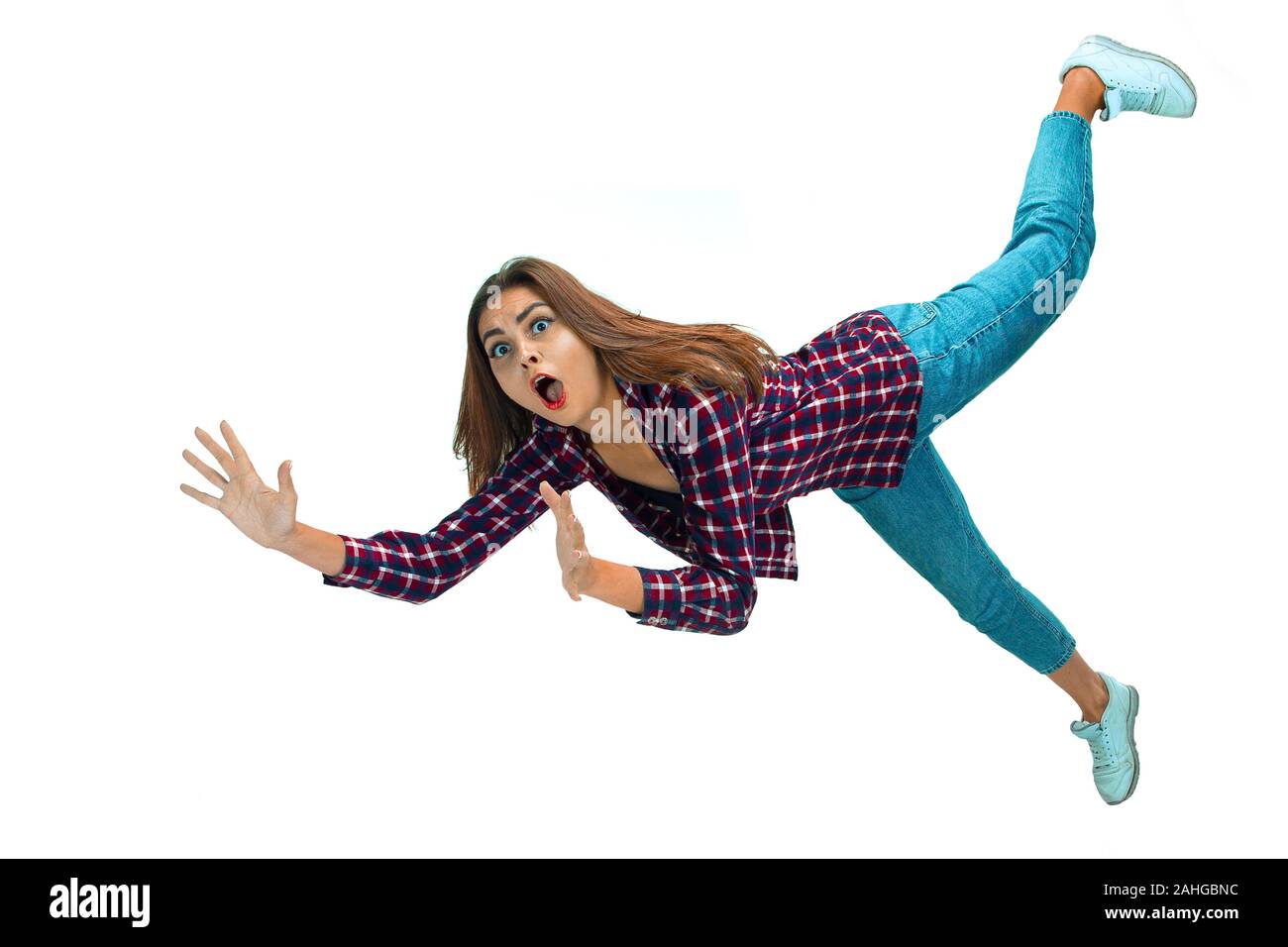 A second before falling. Caucasian young girl falling down in moment ...