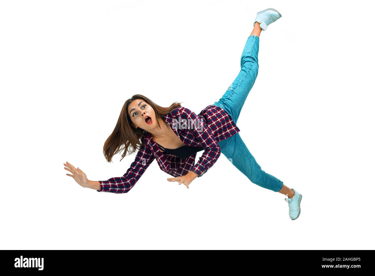 A second before falling. Caucasian young girl falling down in moment ...