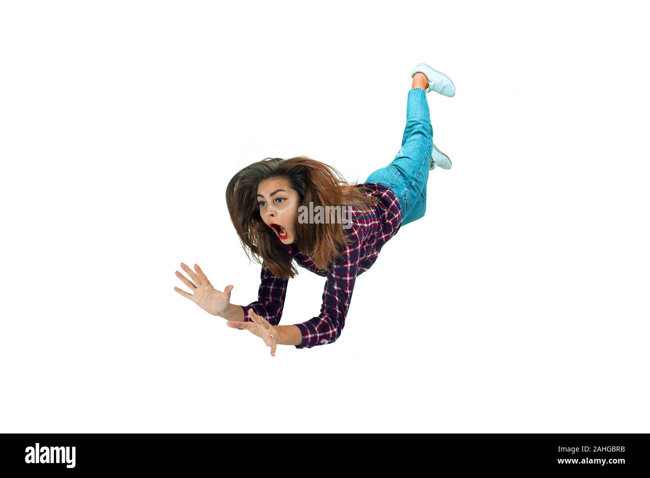 A second before falling. Caucasian young girl falling down in moment ...