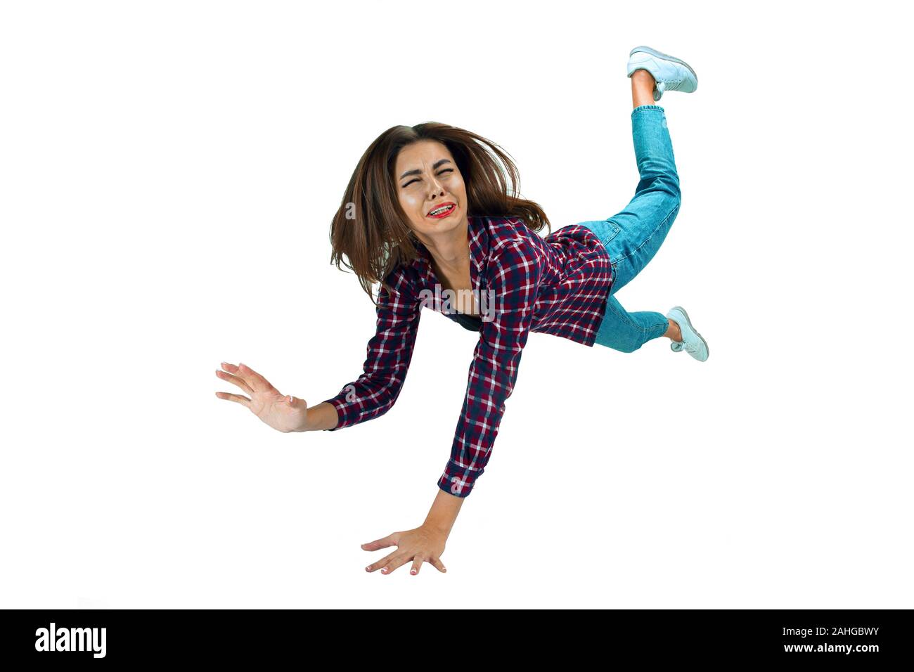 A second before falling. Caucasian young girl falling down in moment ...