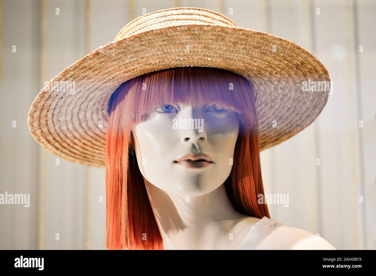 The hat is of straw yellow color on the female head of the dummy in the ...