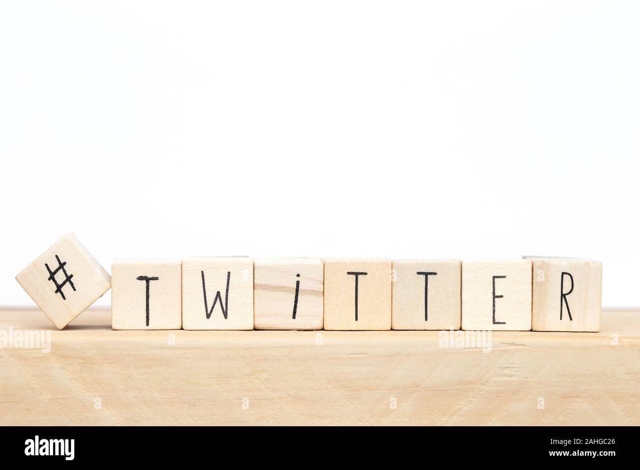 Wooden cubes with a hashtag and the word twitter near white background ...