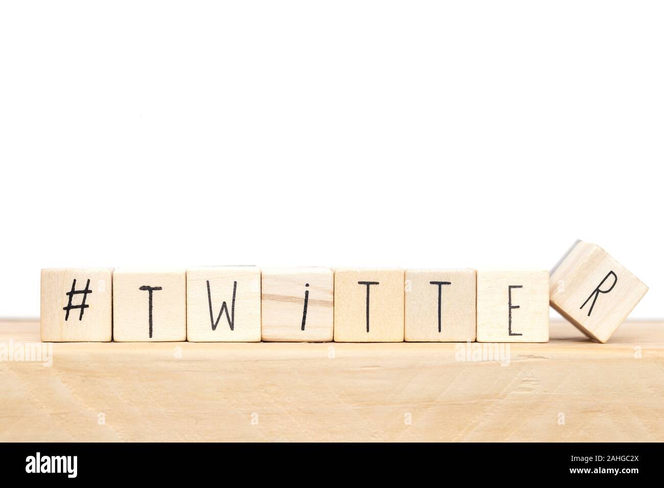 Wooden cubes with a hashtag and the word twitter near white background ...