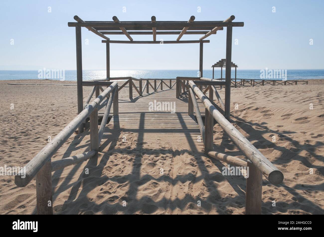 Beach board walk structure heading to blue sea on the background ...