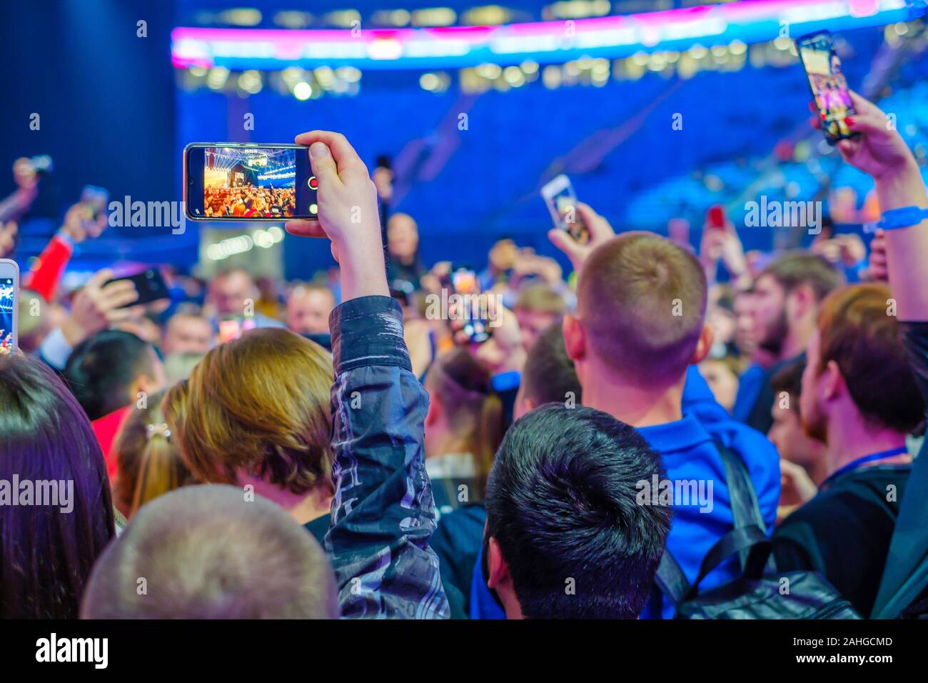 Audience at event uses smartphone camera to take photos and videos ...