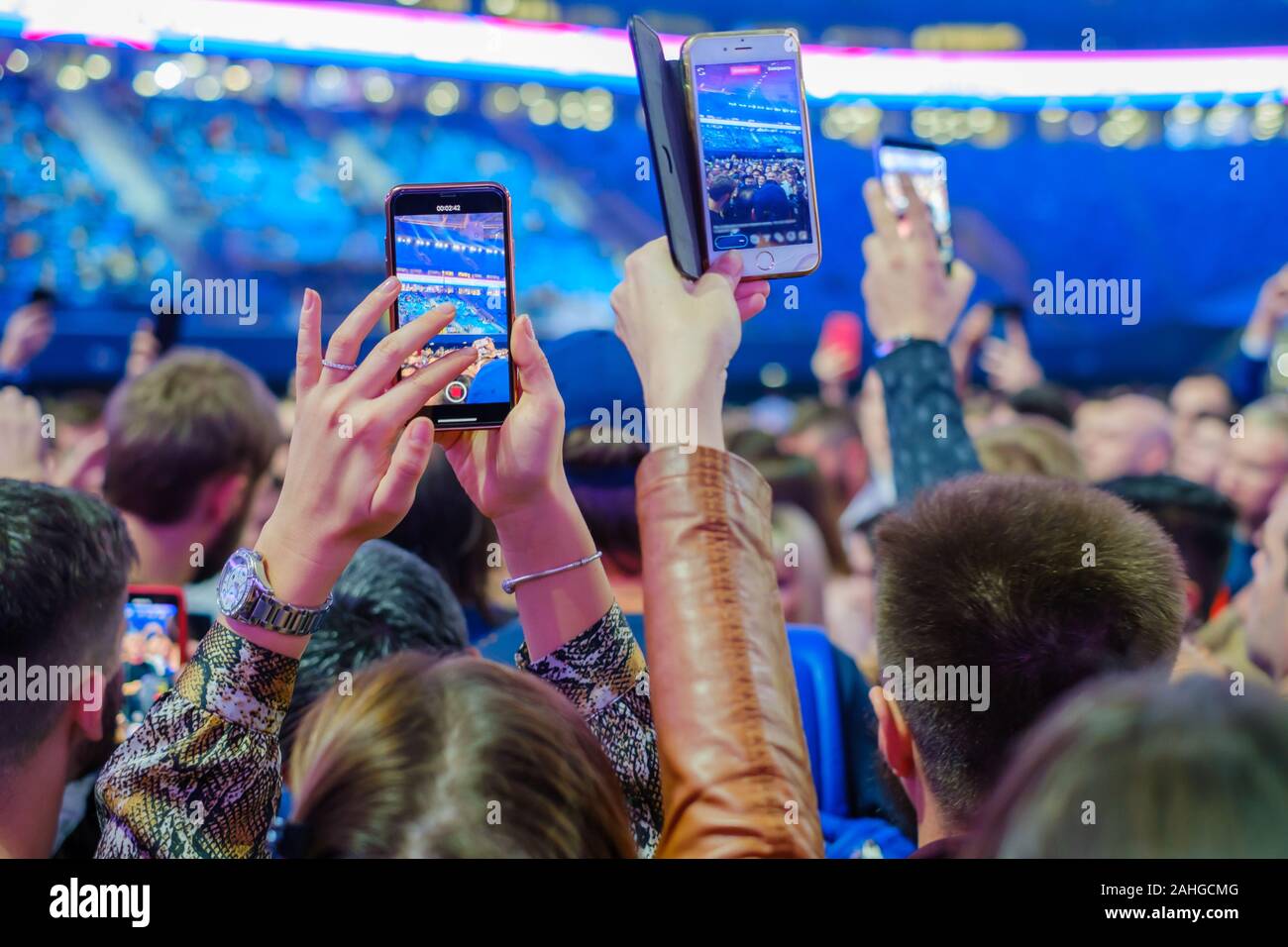 Audience at event uses smartphone camera to take photos and videos ...