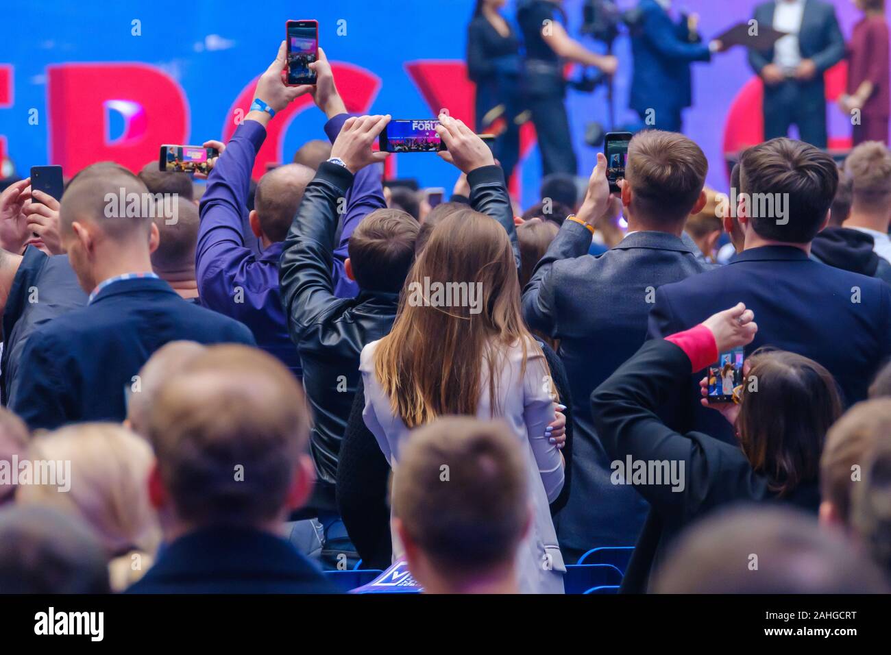 Audience at event uses smartphone camera to take photos and videos ...