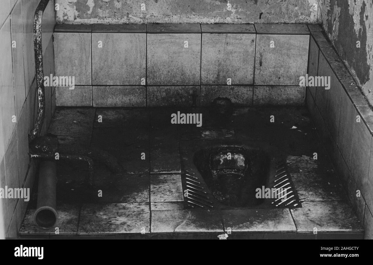 public toilet in third world countries. dirt and feces are smeared on ...