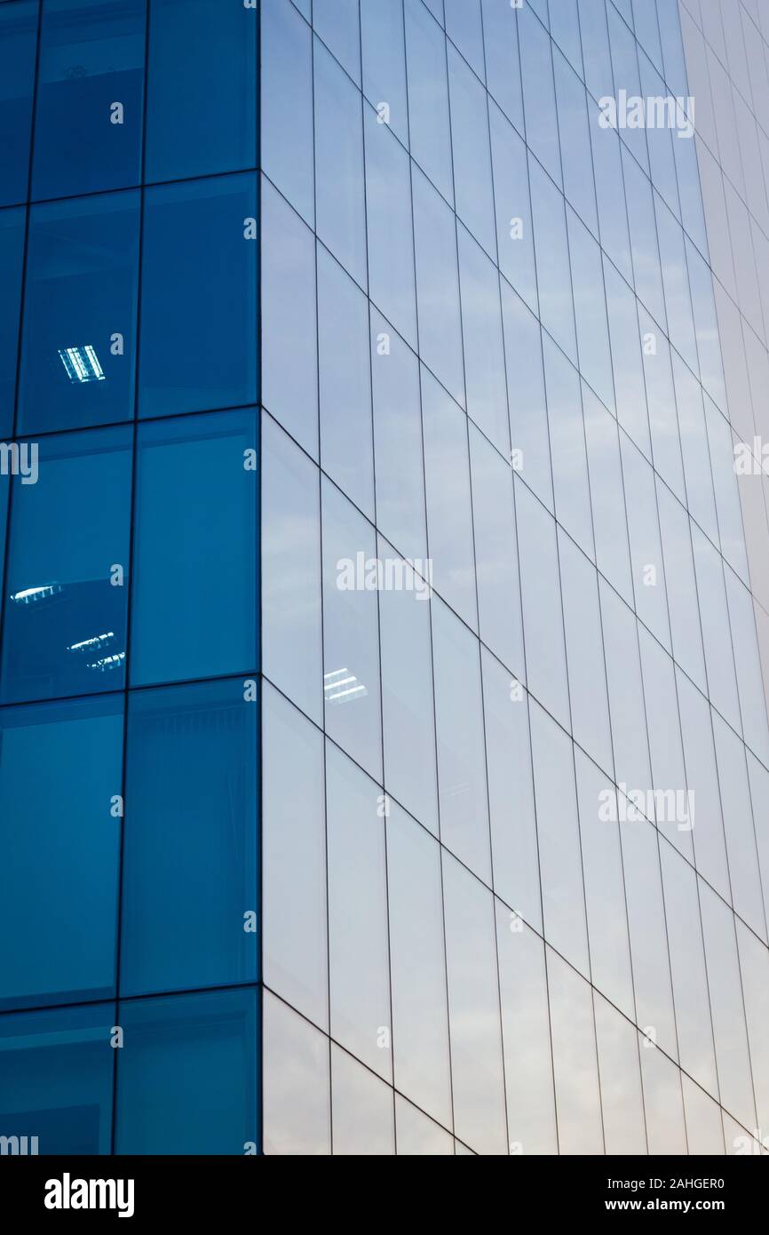 Vertical view of office building corner windows front facade in ...