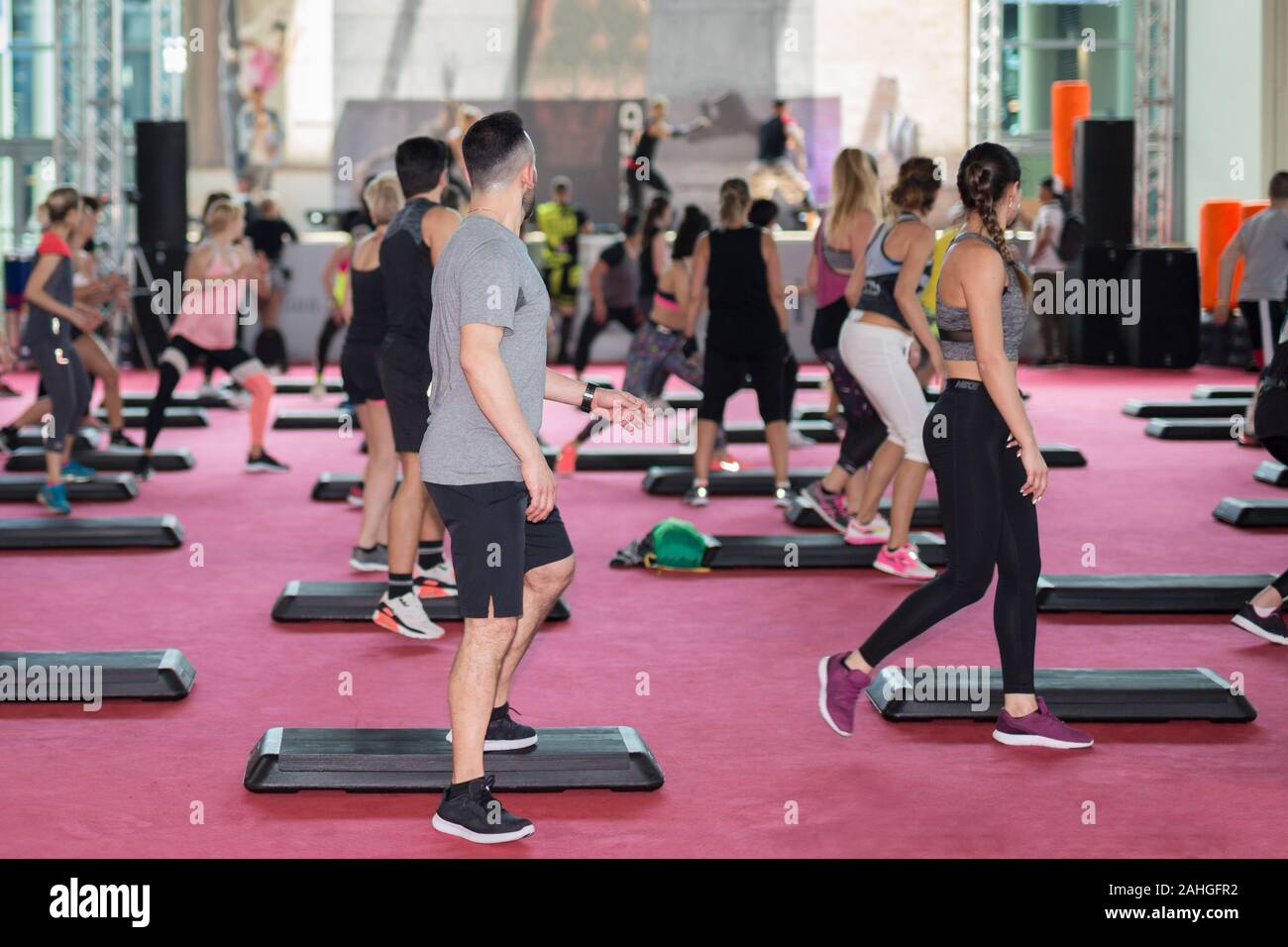 Fitness Workout in Gym: People doing Exercises in Class with Step ...