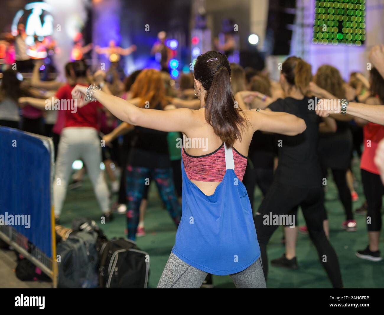 Fitness Workout in Gym: People doing Exercises in Class with Music and ...