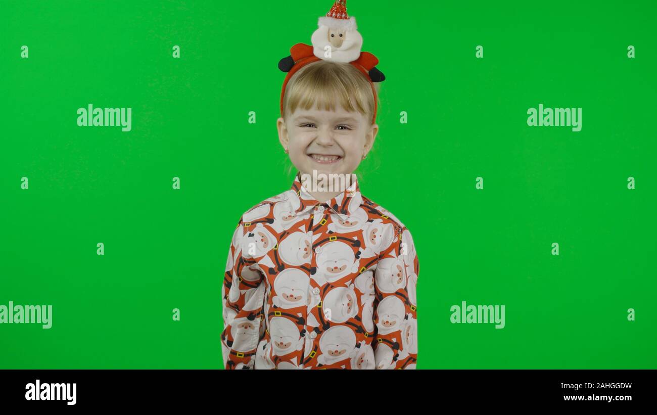 Happy beautiful little baby girl in a shirt with a Santa Claus ...