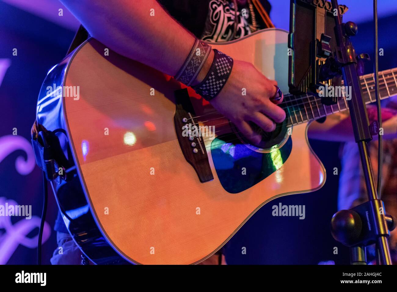 The singer plays an acoustic guitar and sings at a concert Stock Photo ...