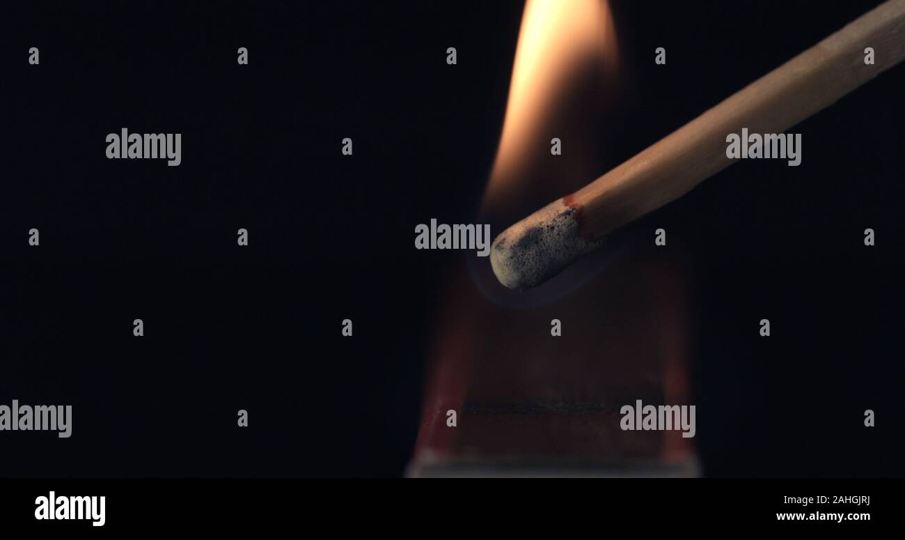 Firing up matches. Ignition lose-up detail of on matchbox and showing ...