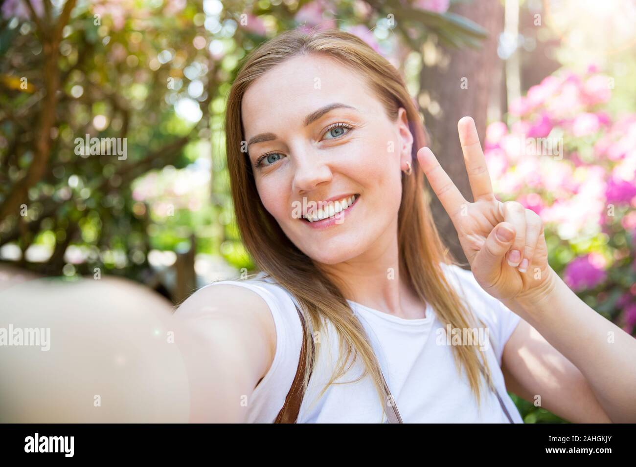 Beautiful Woman Traveling In Tropic Forest With Flowers Walking Along