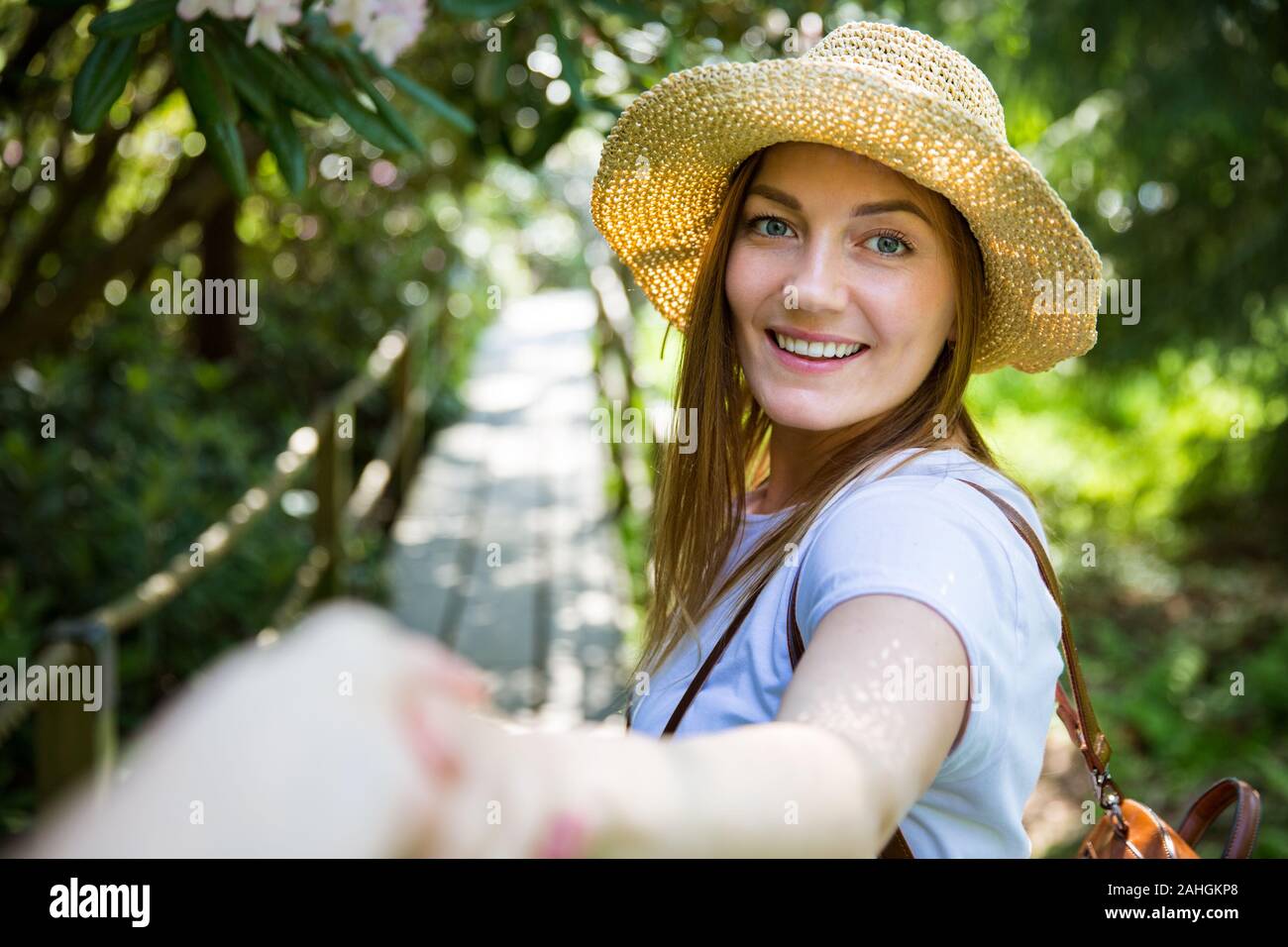 Beautiful woman in straw hat travel in tropic forest, walking along ...